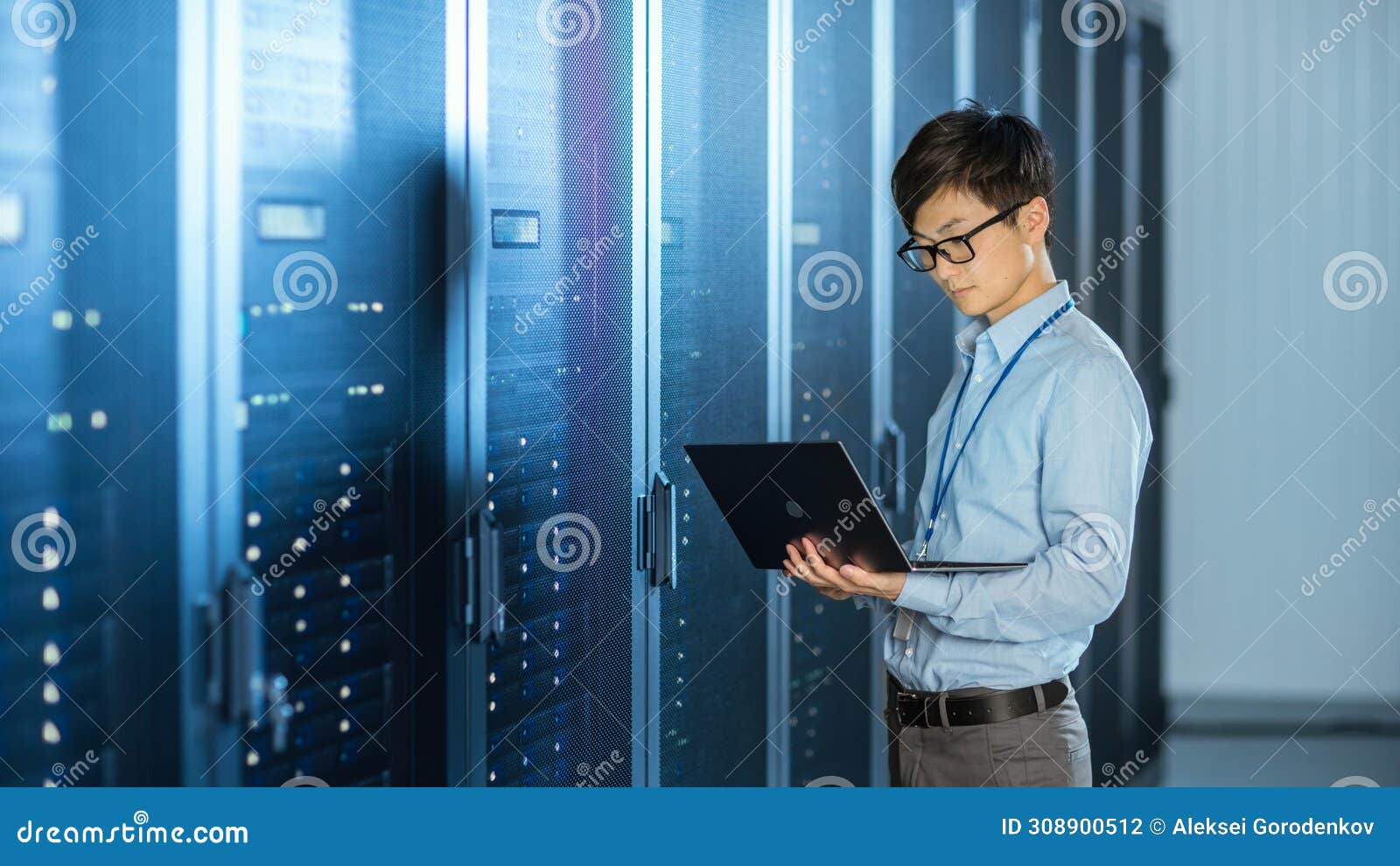 In the Modern Data Center: it Engineer Standing beside Server Rack ...