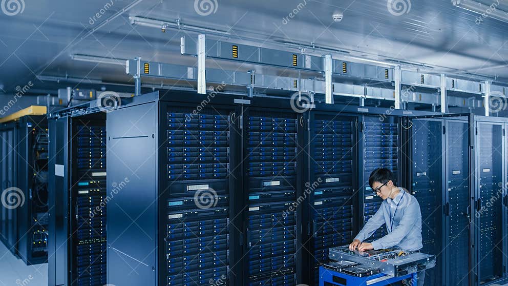 In the Modern Data Center: it Technician Working with Server Racks, on ...