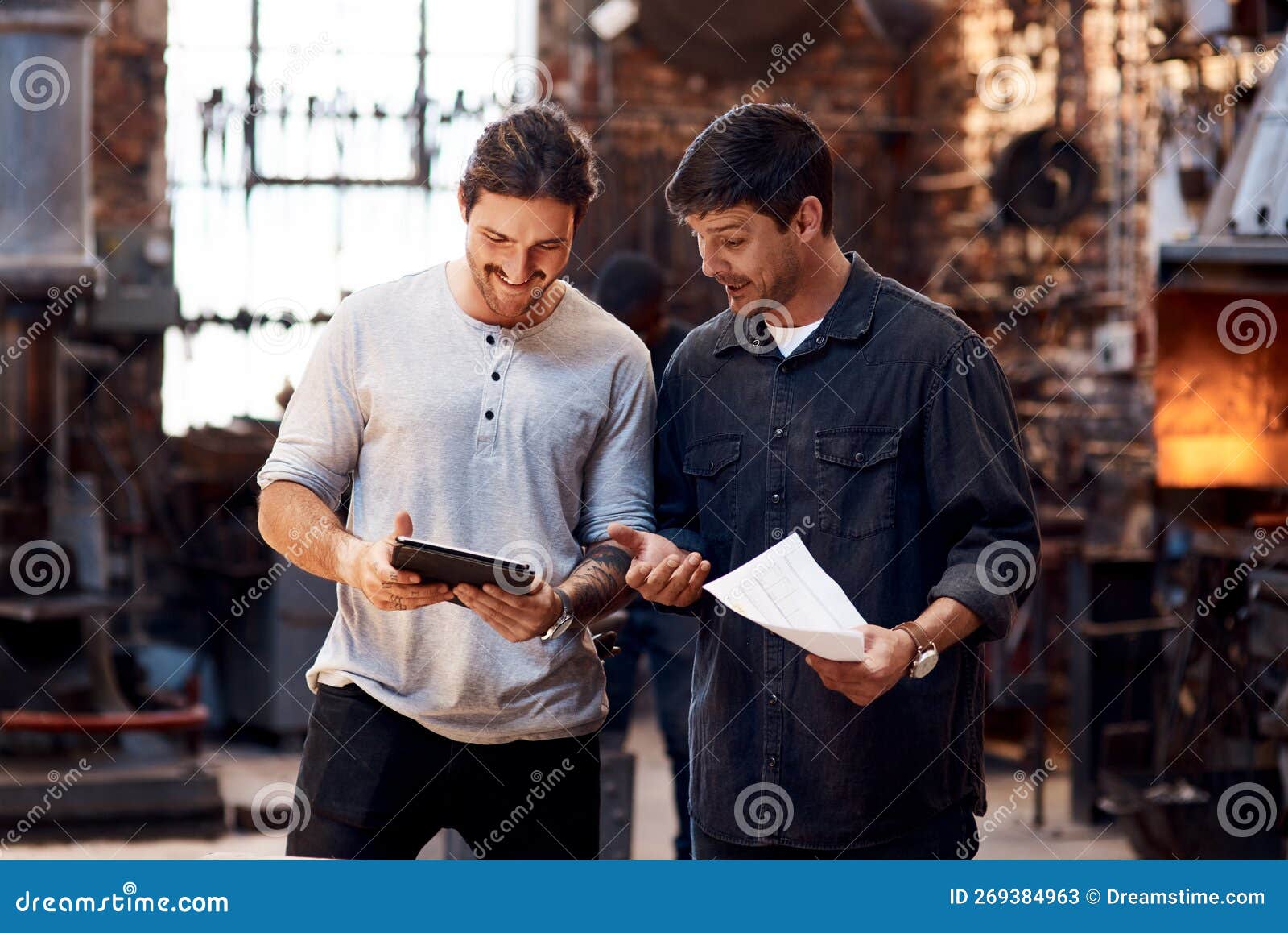 Modern Day Business Requires Modern Day Tools. Two Handsome Young Using ...