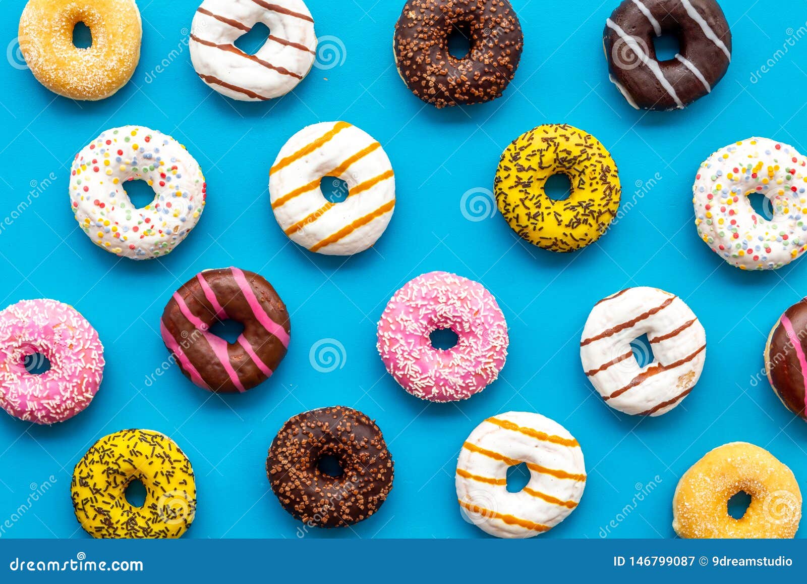 Modern Design with Bright Donuts on Blue Background Top View Pattern ...