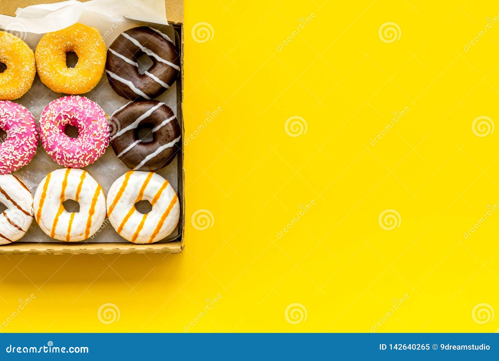 Modern Design with Donuts in Box on Yellow Background Top View Space ...