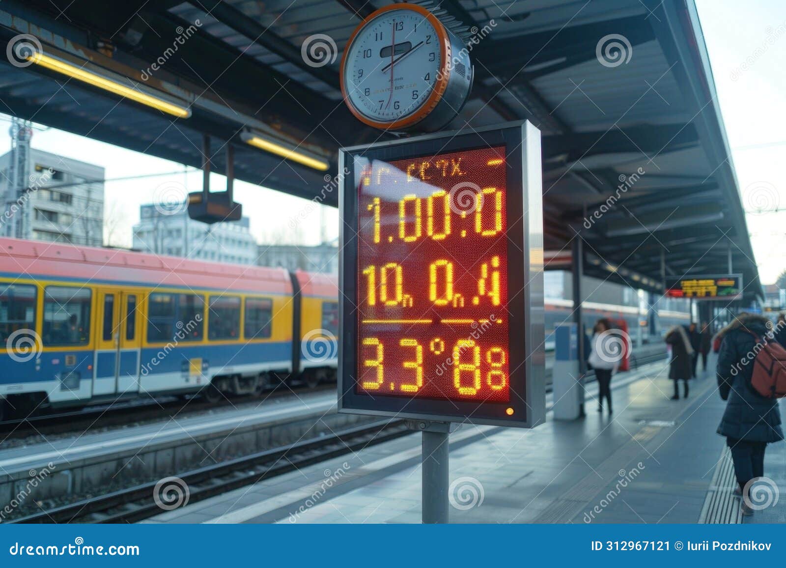 Modern Digital Clock at a Train Station with a Train in the Background ...