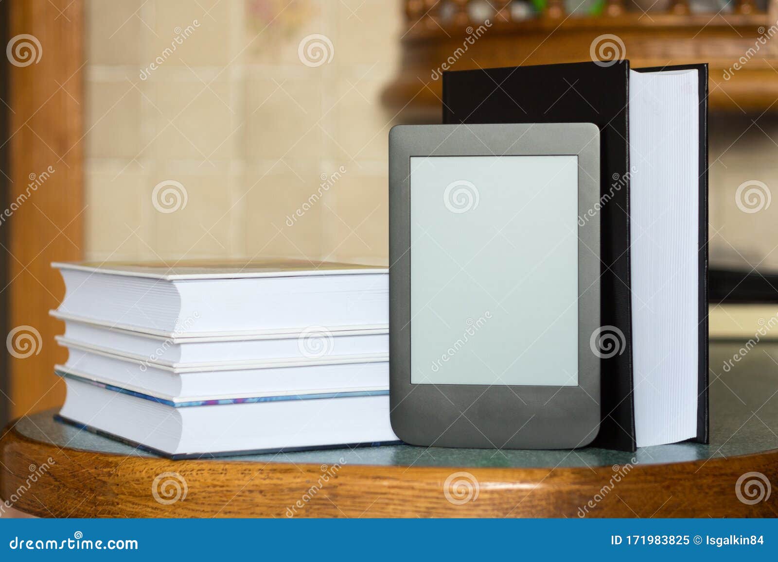 Modern E-book on the Background of a Stack of Thick Paper Books Stock ...