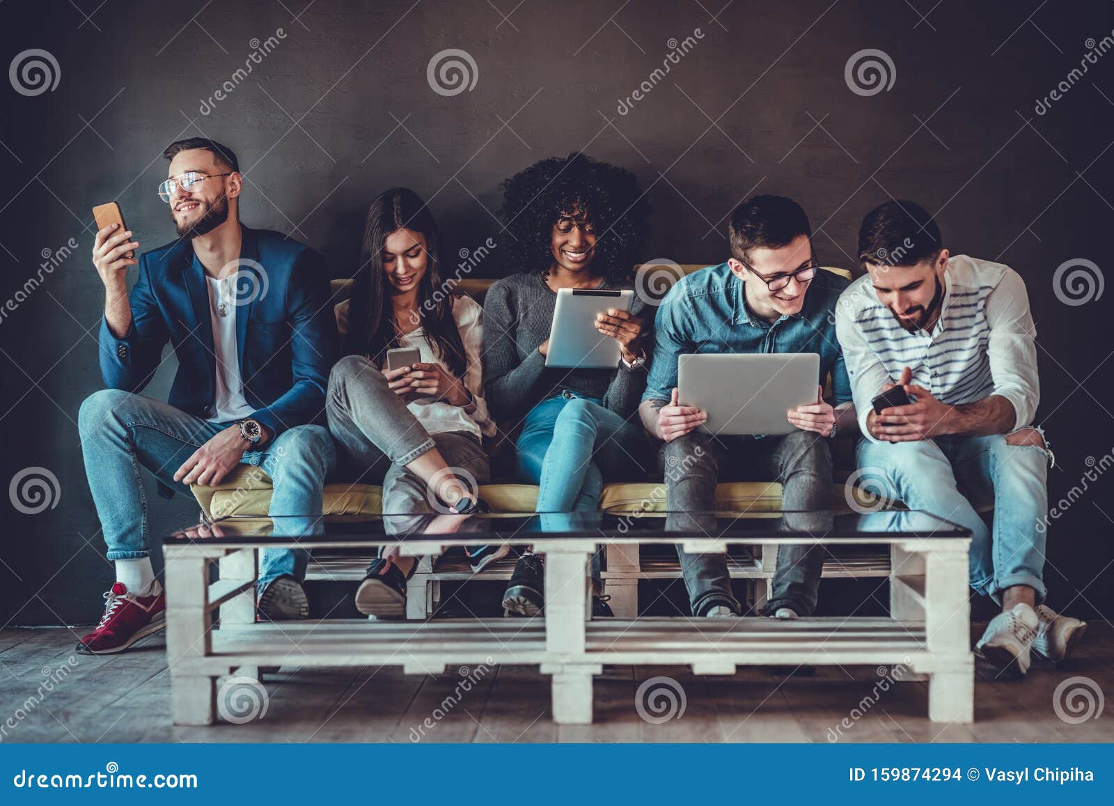 Diverse Students Using Gadgets Sit Sofa Stock Photos - Free & Royalty ...