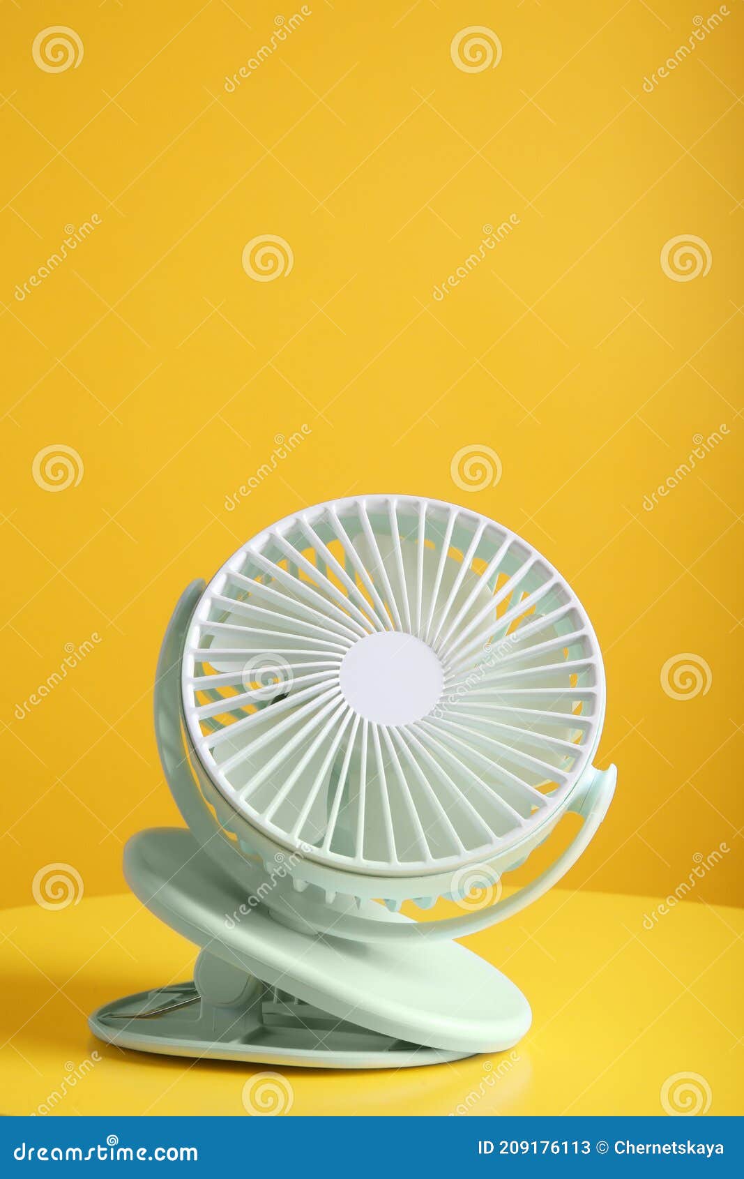 Modern Electric Fan on Table Against Yellow Background Stock Image ...