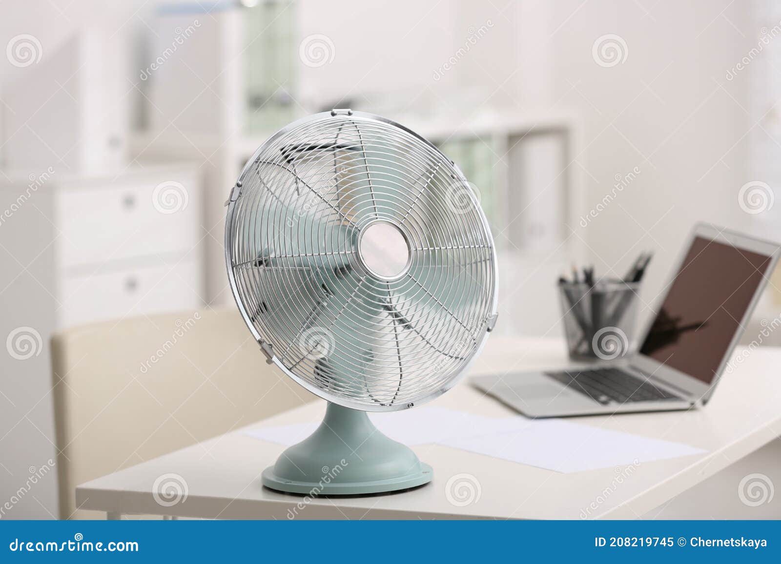 Modern Electric Fan on Table in Office Stock Image - Image of indoors ...