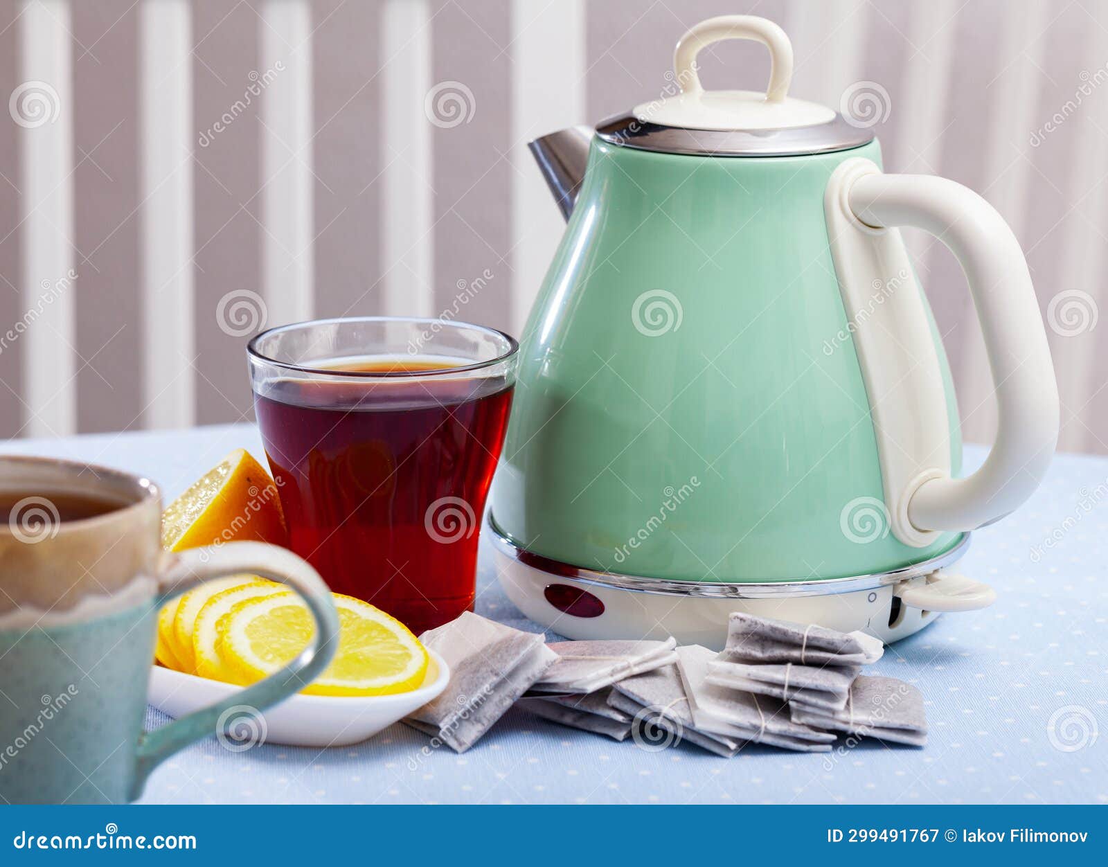 Modern Electric Kettle, Cup and Lemon on Table in Kitchen Stock Image ...