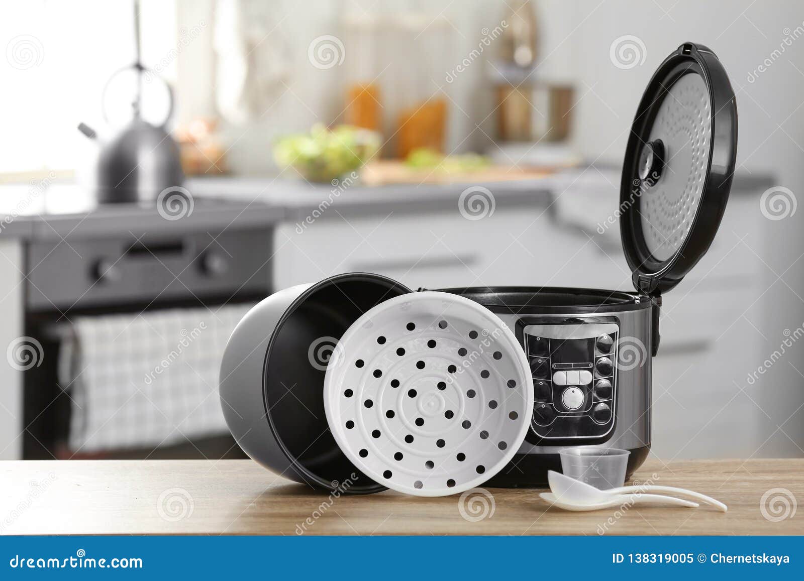 Modern Electric Multi Cooker, Parts and Accessories on Table in Kitchen ...