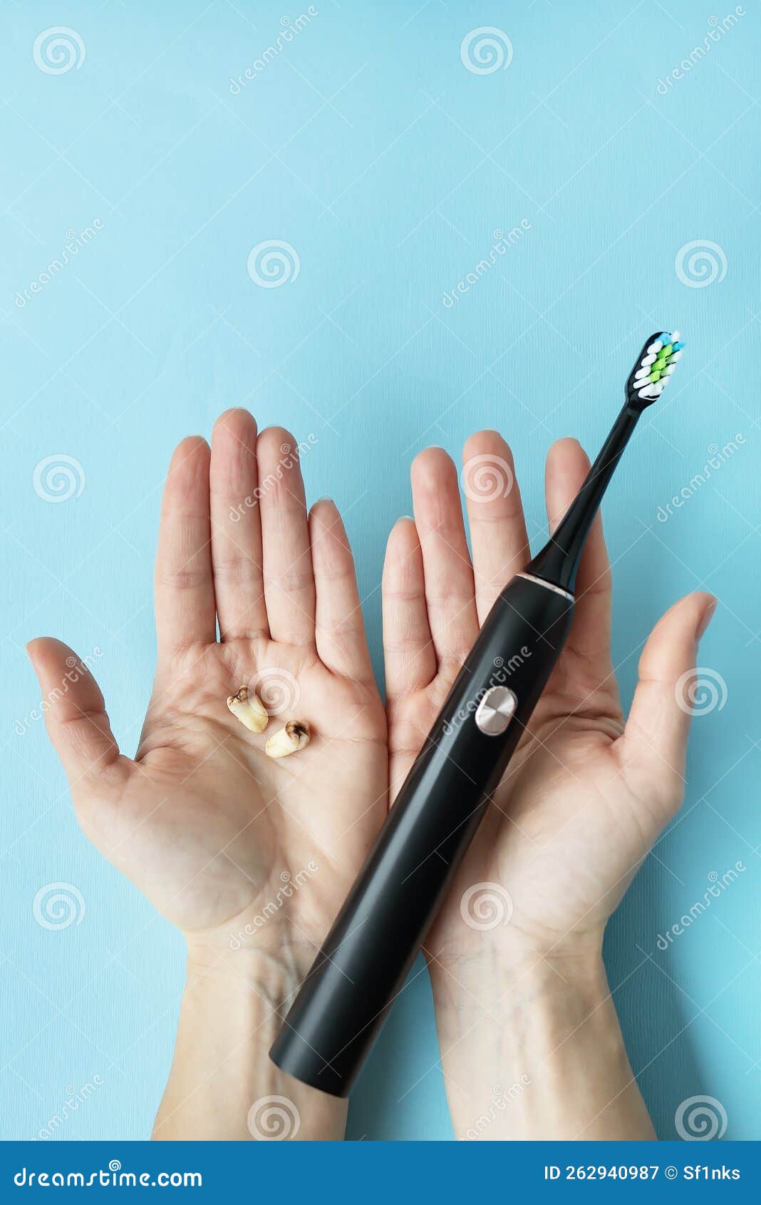 A Modern Electric Toothbrush in One Hand and Pulled Teeth in the Other ...
