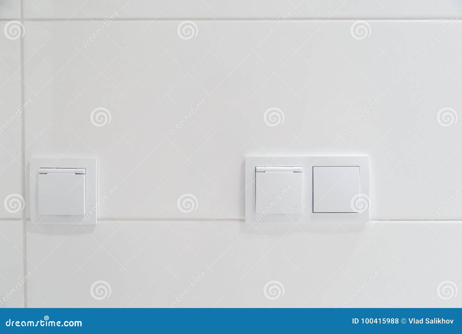 Modern Electrical Switches on a White Wall of Tiles Stock Photo - Image ...