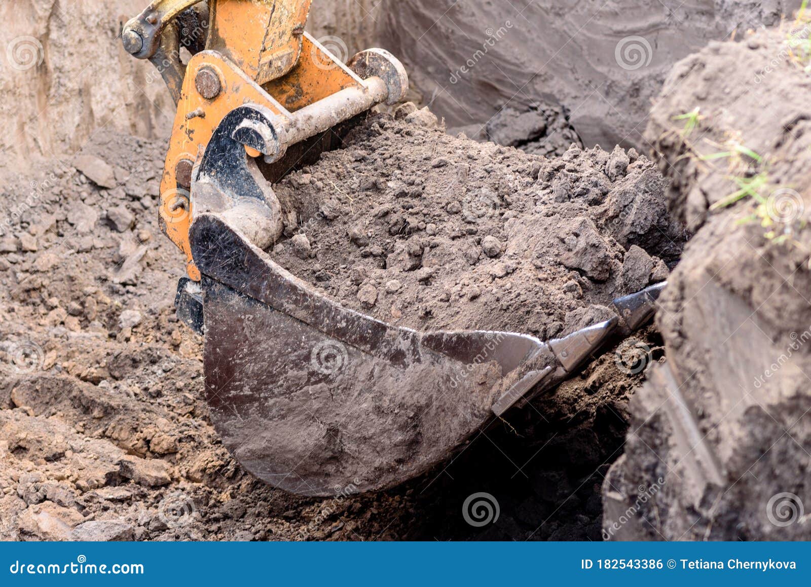 The Modern Excavator Performs Excavation Work on the Construction Site ...