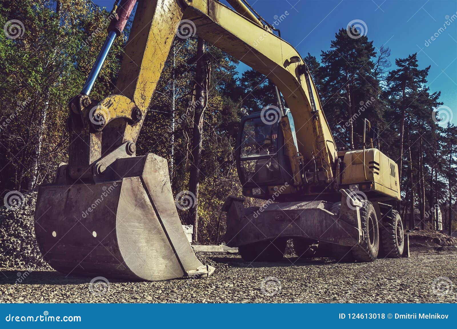 The Modern Excavator Performs Excavation Work on the Construction Site ...