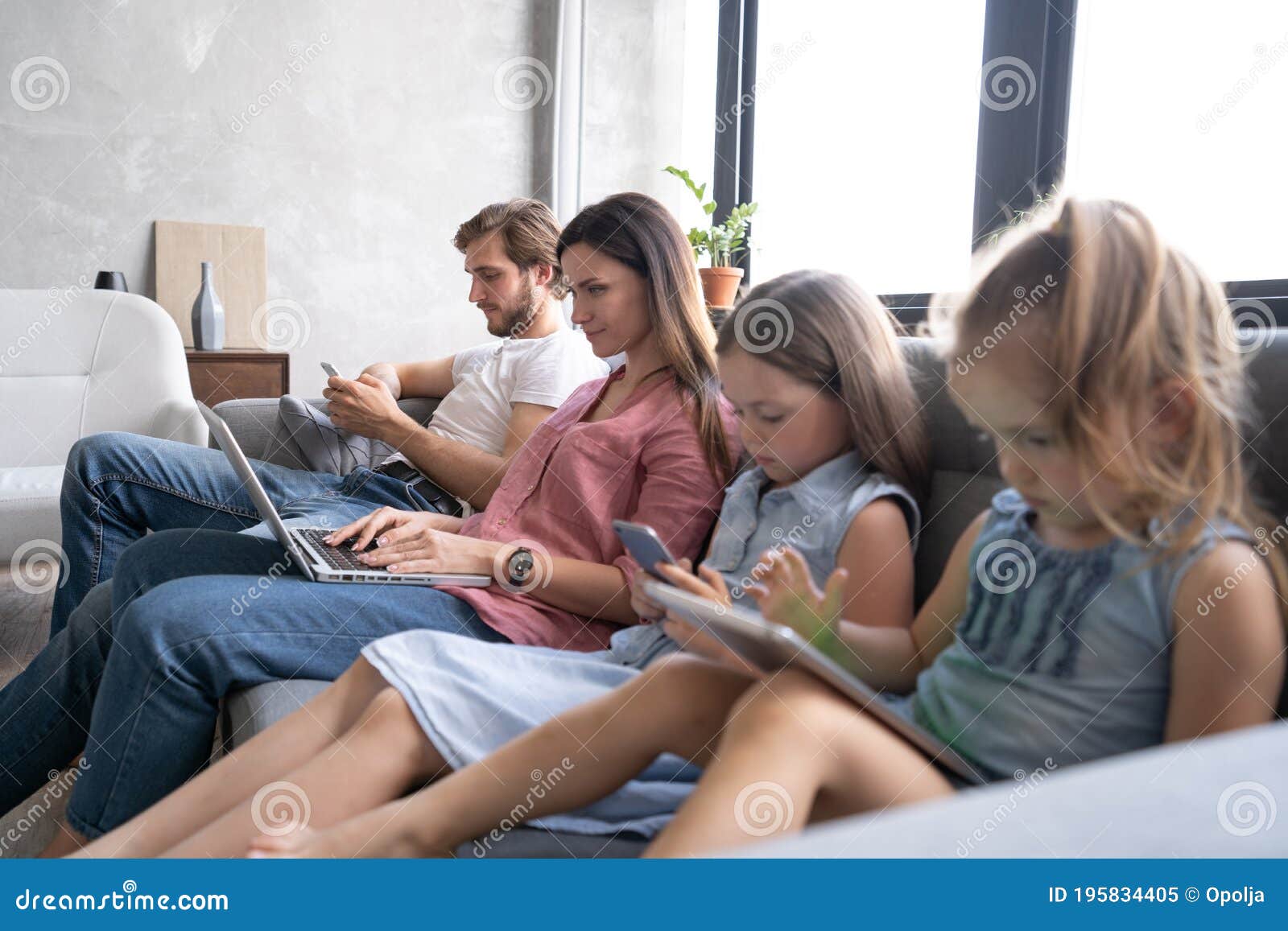 Modern Family Values. Father, Mother and Daughters Using Electronic ...