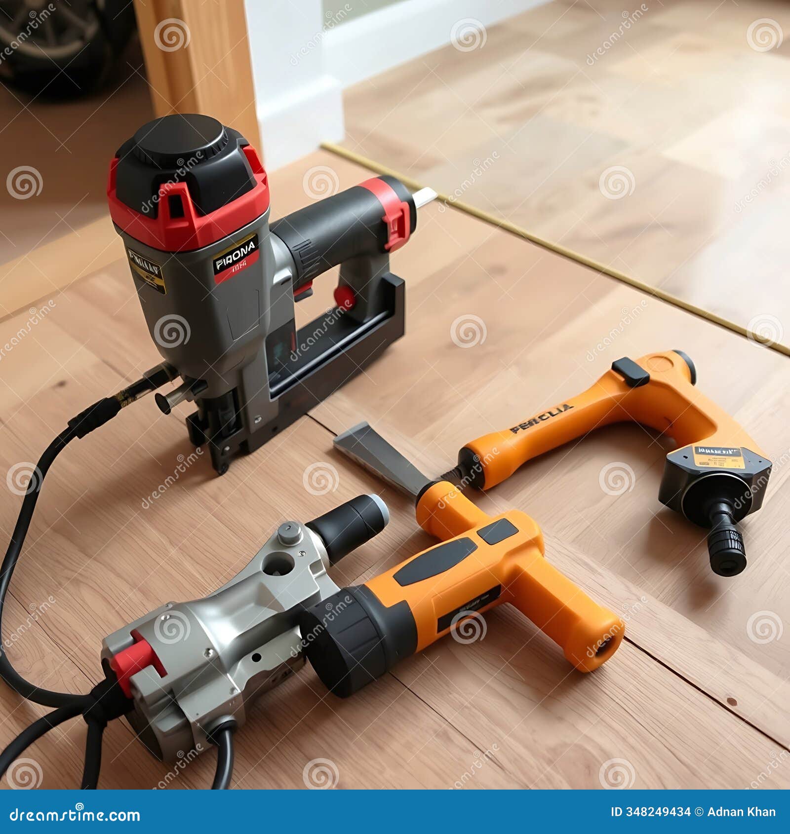 A Modern Flooring Installation Setup with a Pneumatic Stapler Hammer and Cutting Tools Stock ...