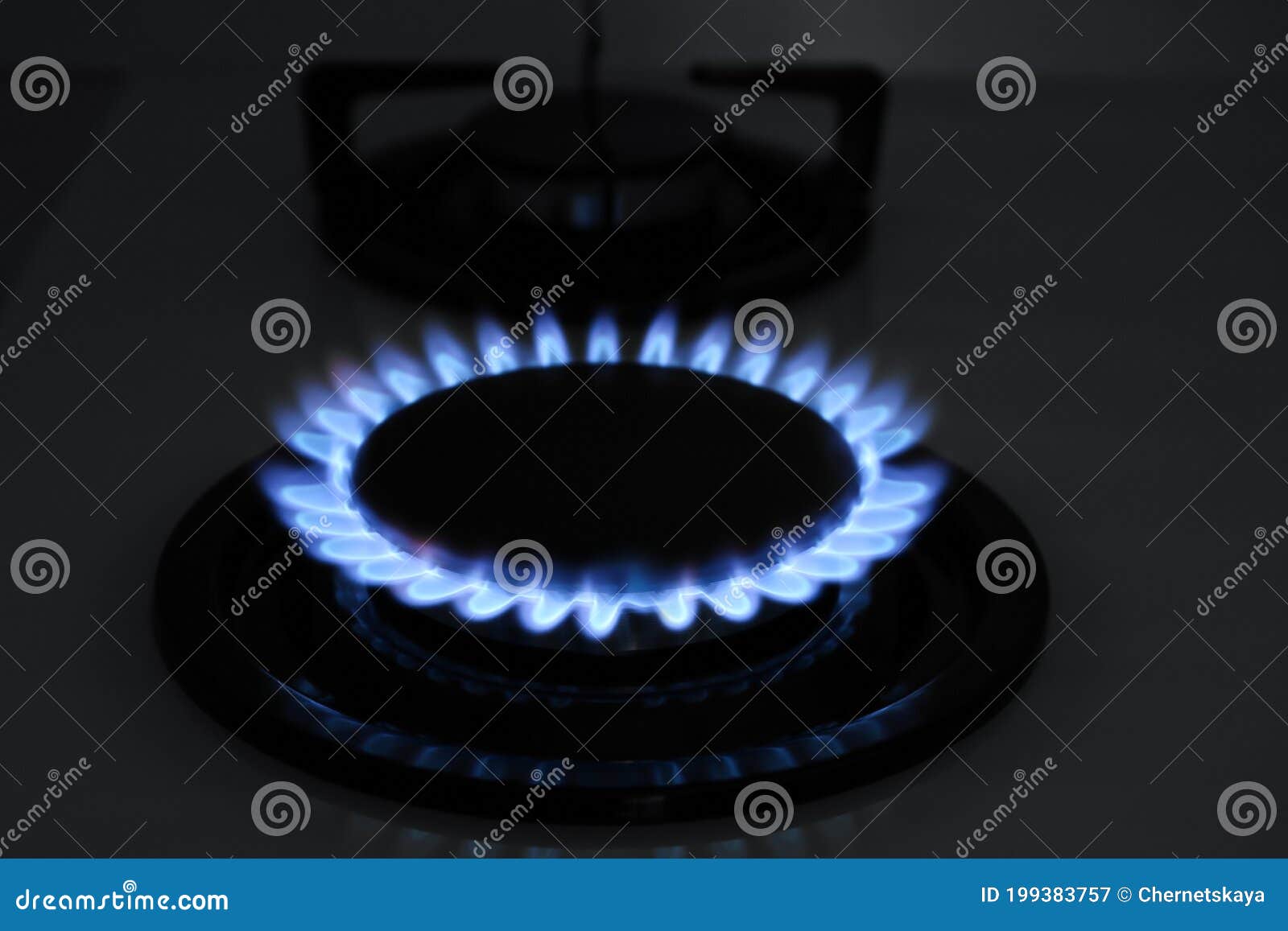 Modern Gas Cooktop with Burning Blue Flame in Kitchen at Night Stock ...