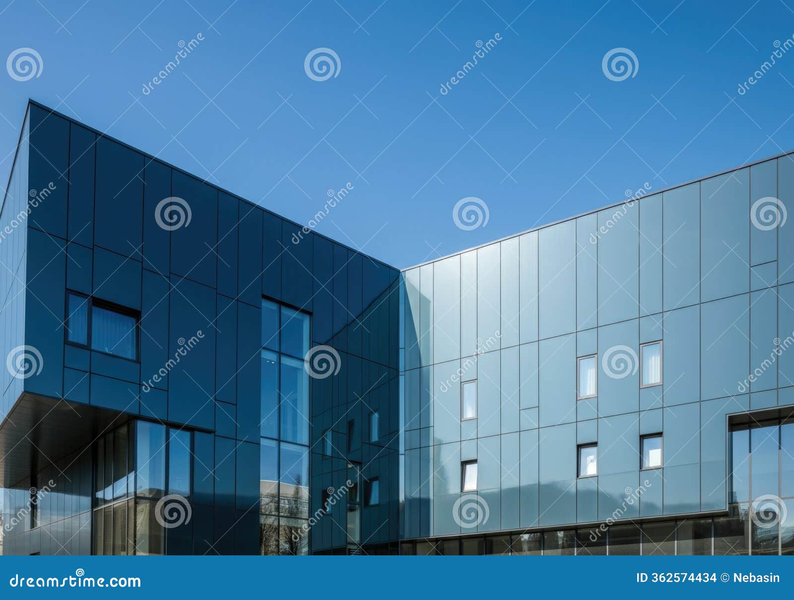 Modern Glass Building Exterior with Reflective Facade Under Clear Blue ...