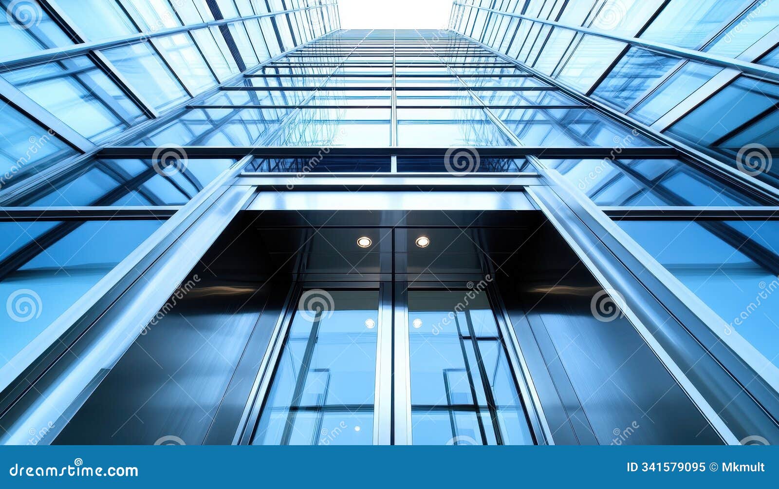 Modern Glass Building Facade with Elevator Doors Under Bright Sky at ...