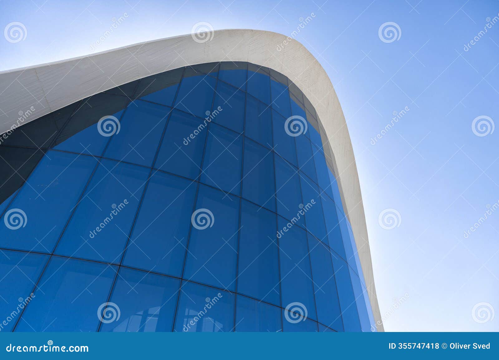 Modern Glass Curved Building Against Deep Blue Sky Stock Photo - Image ...