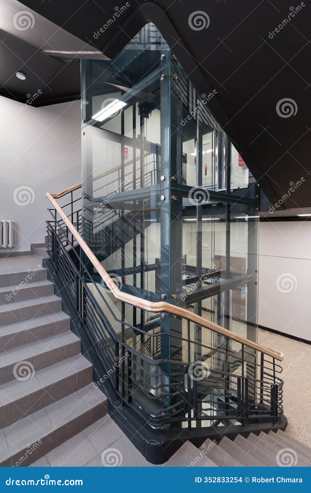 Modern Glass Elevator and Winding Staircase Design Stock Photo - Image ...