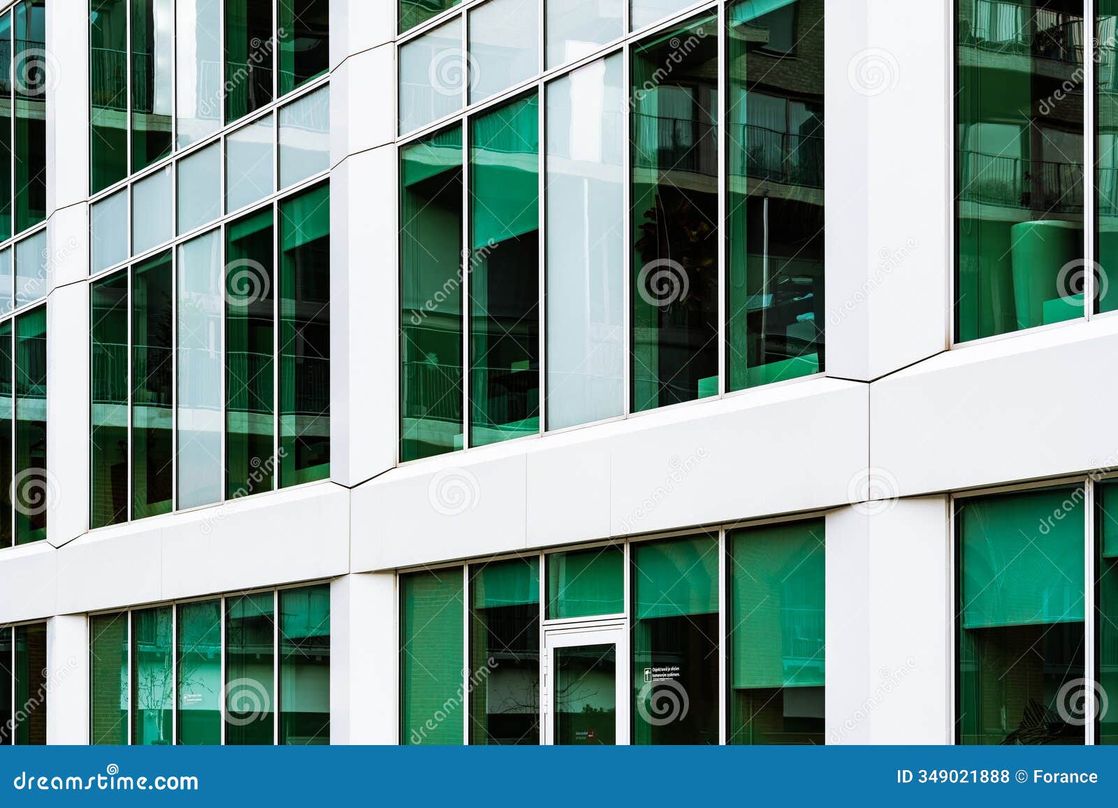 Modern Glass Facade with Reflective Panels and Angular Architectural ...