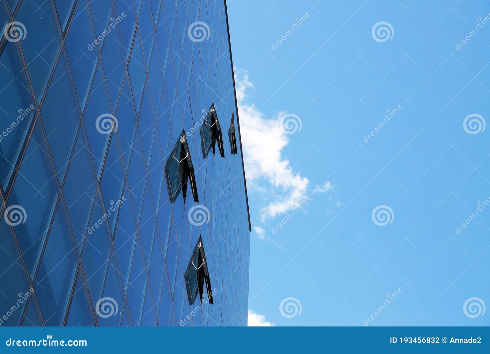 Modern Glass Facade of a Skyscraper Against the Backdrop of a Sunny ...