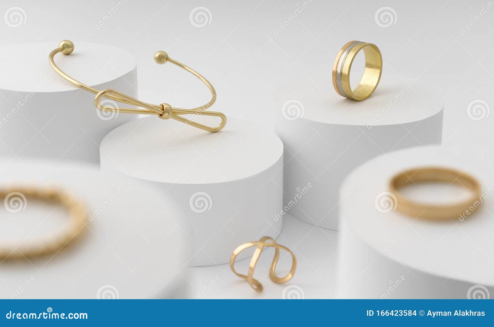Modern Golden Bow Shape Bracelet and Rings Collection on White ...