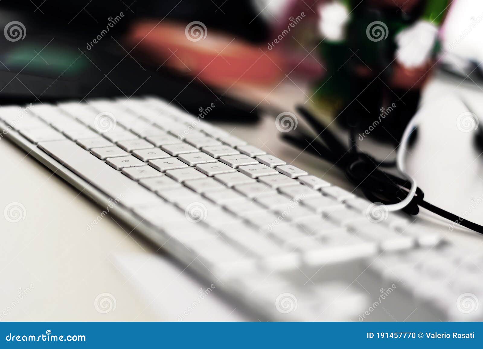 A Modern Gray Computer Keyboard with White Keys on an Office Table ...