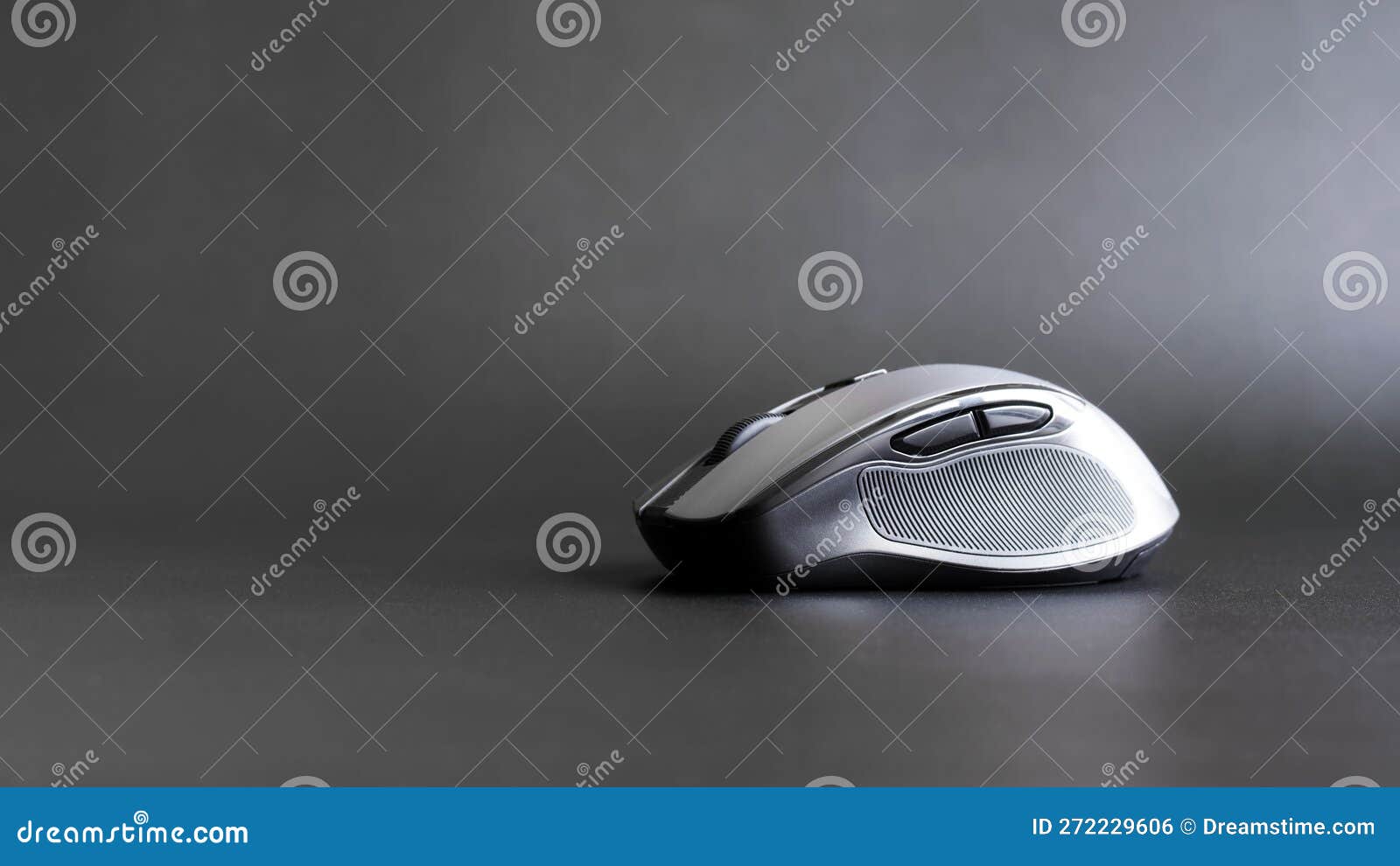 Modern Gray Wireless Computer Mouse on a Gray Textured Background. Side ...