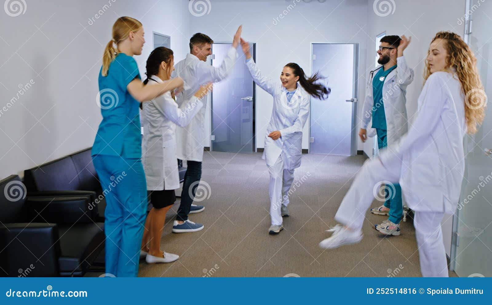 In a Modern Hospital Corridor Dancing Excited Doctors and Nurses with a ...