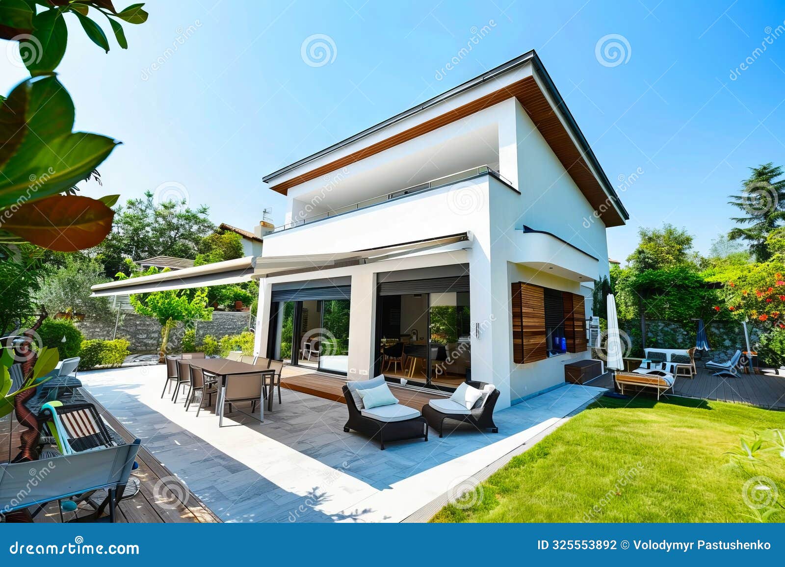 A Modern House with a Large Patio and Lawn Stock Photo - Image of lawn ...