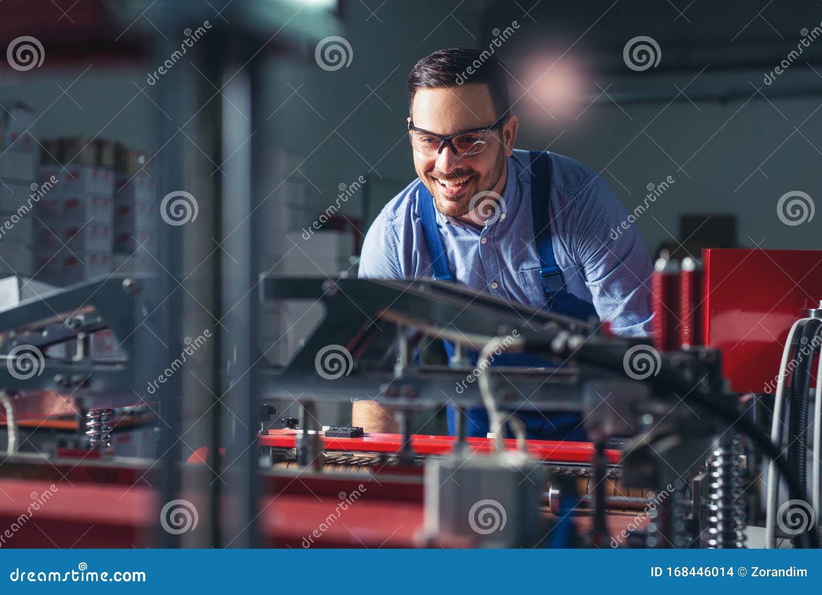 Modern Industrial Machine Operator Working in Factory. Worker on the ...