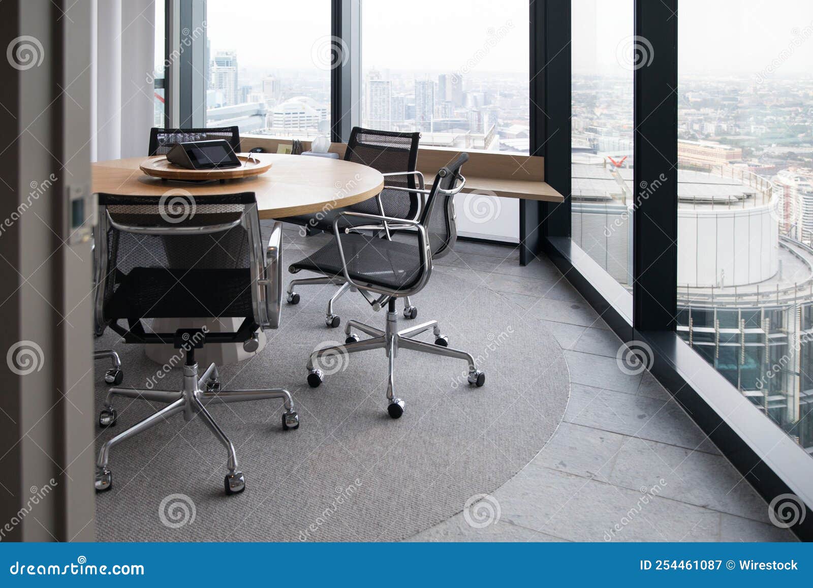 Modern Interior Design for an Office with a Round Table and Chairs Near ...