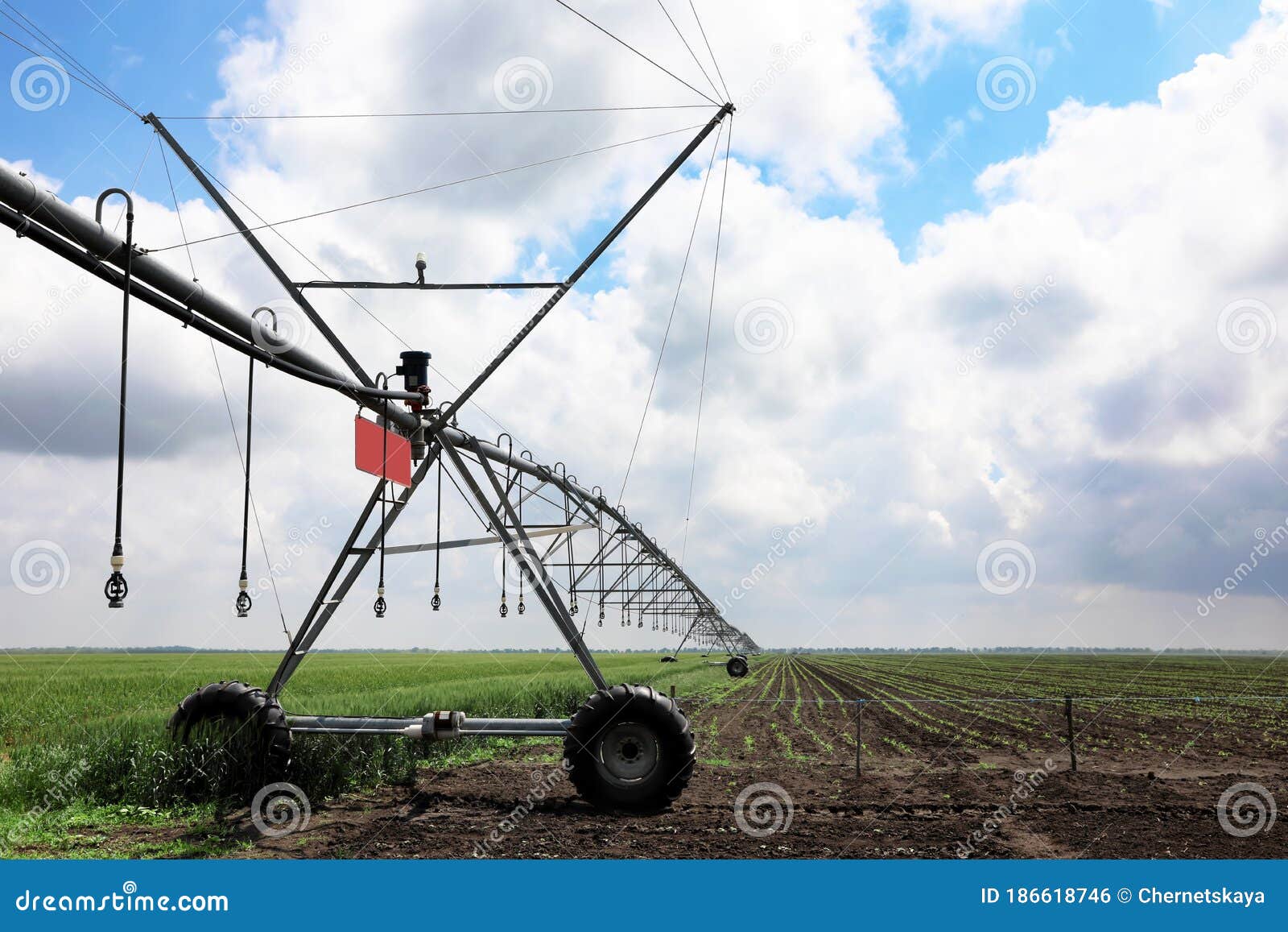 Modern Irrigation System in Field Under Sky. Agricultural Equipment ...