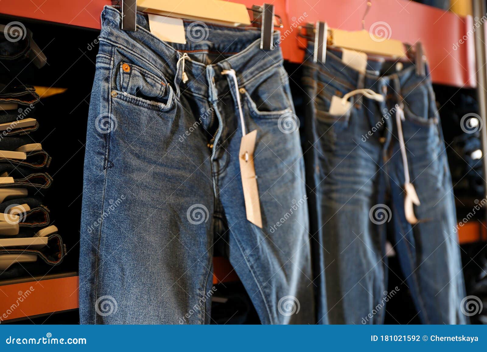 Jeans Hanging on Shelf in Shop Stock Photo - Image of outfit, sale ...