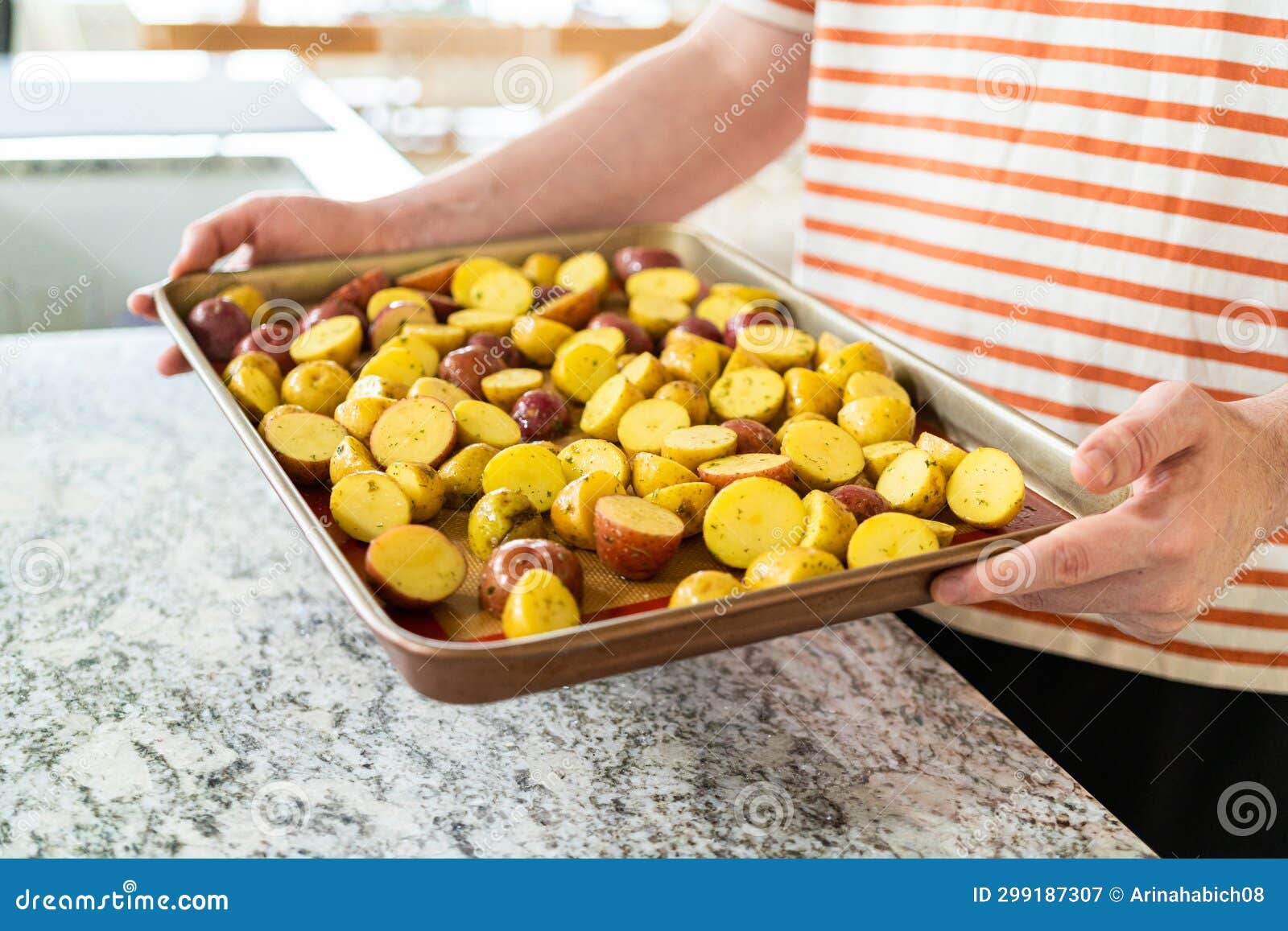 Roasting Halved Mixed Marble Potatoes in Modern Kitchen Stock Image ...