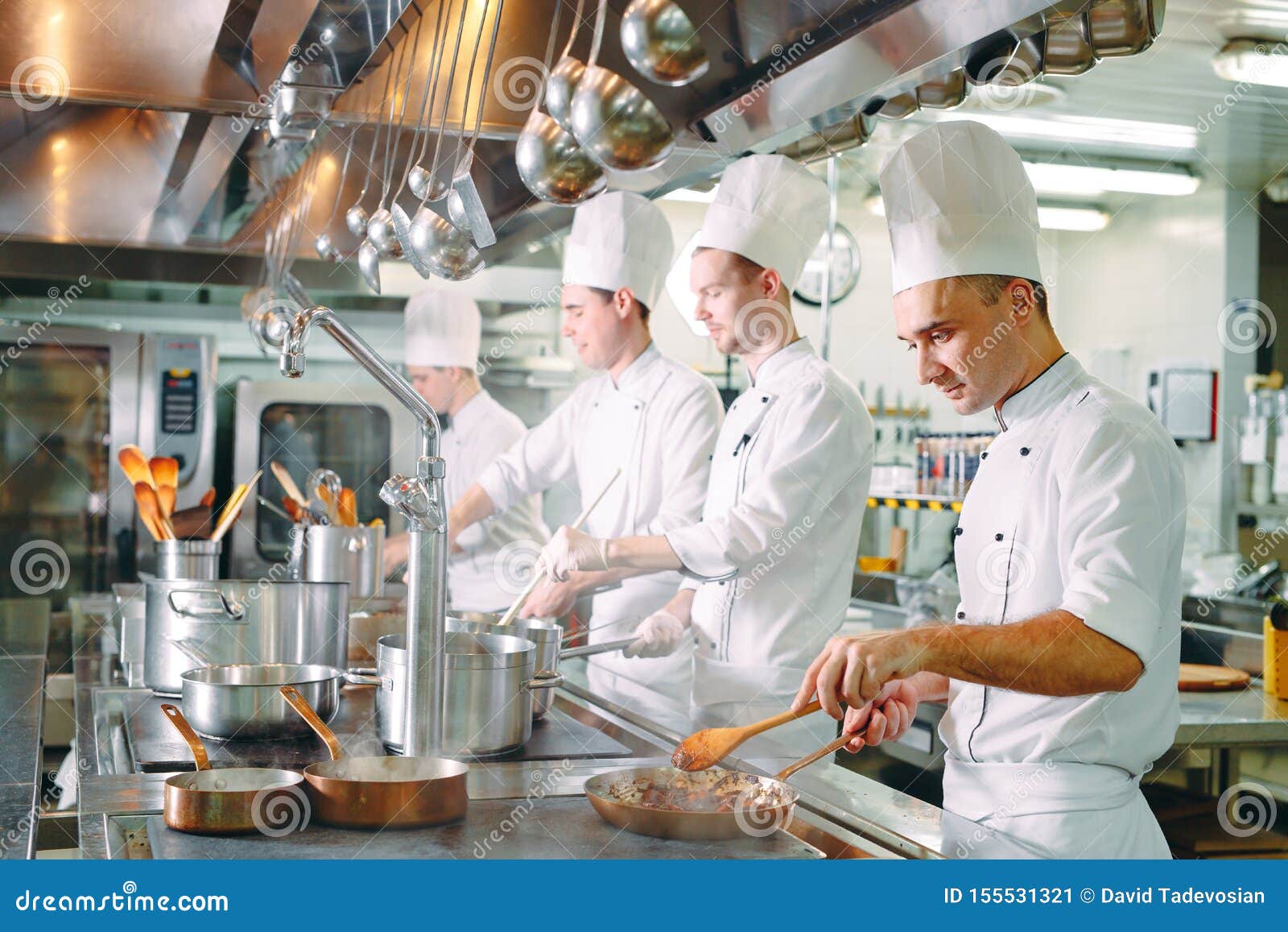 Modern Kitchen. Cooks Prepare Meals on the Stove in the Kitchen of the ...
