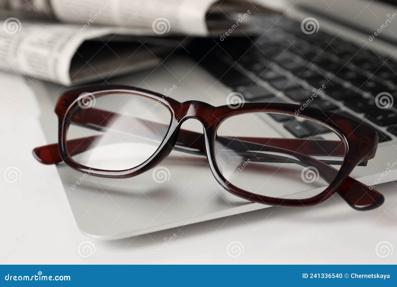 Modern Laptop and Glasses on White Table, Closeup Stock Photo - Image ...
