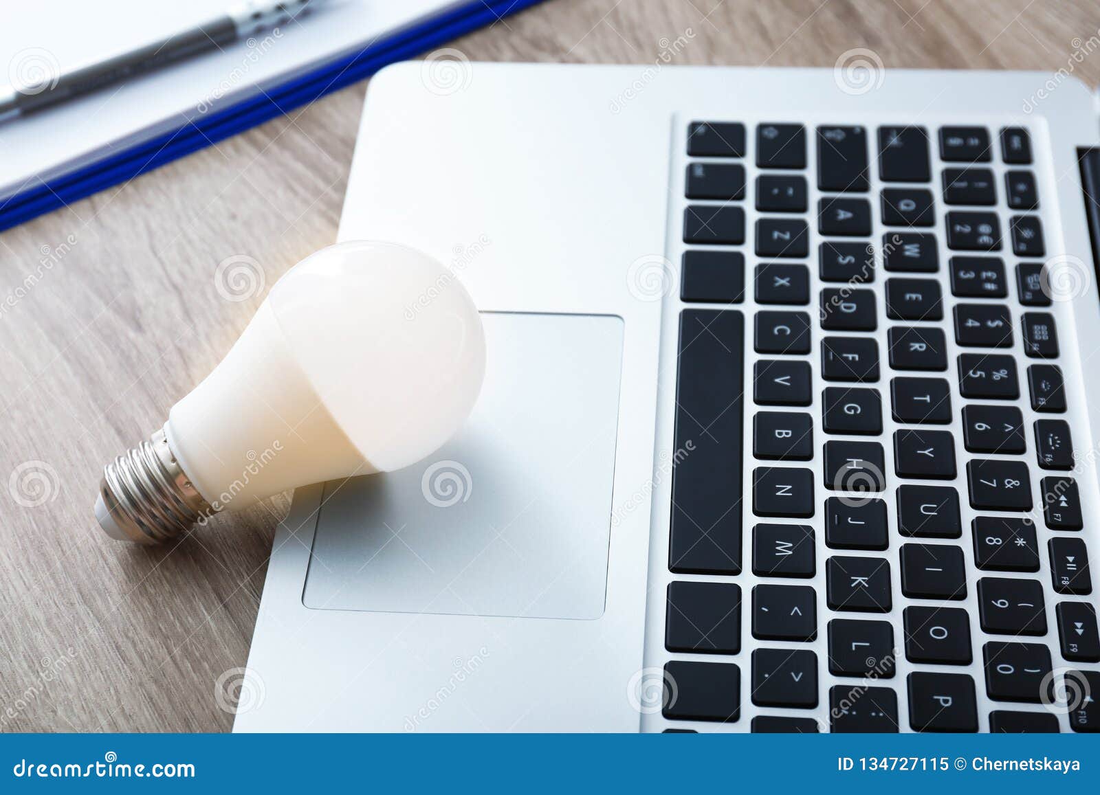 Modern Laptop and Lamp Bulb on Office Table Stock Image - Image of ...