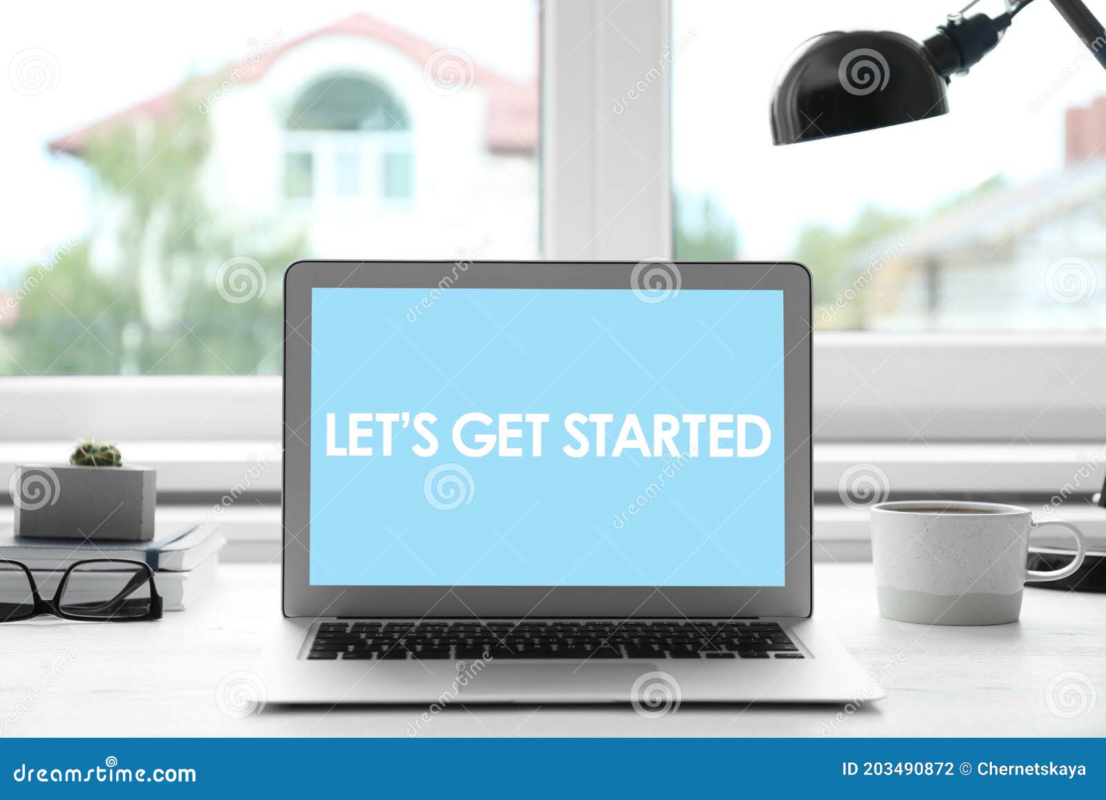 Modern Laptop with Phrase Let`s Get Started on Screen in Office Stock ...