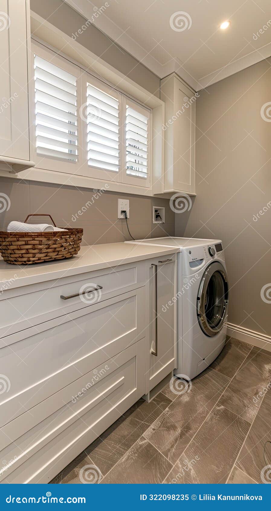 A Modern Laundry Room with a Front-loading Washing Machine and Neatly ...