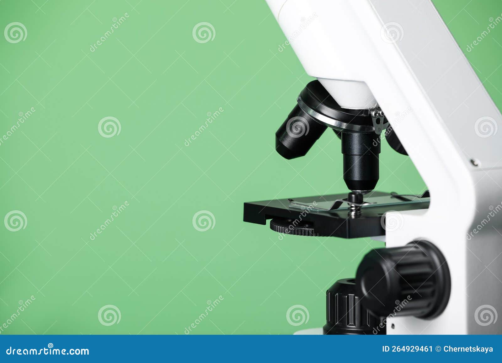 Modern Medical Microscope with Glass Slide on Green Background, Closeup ...