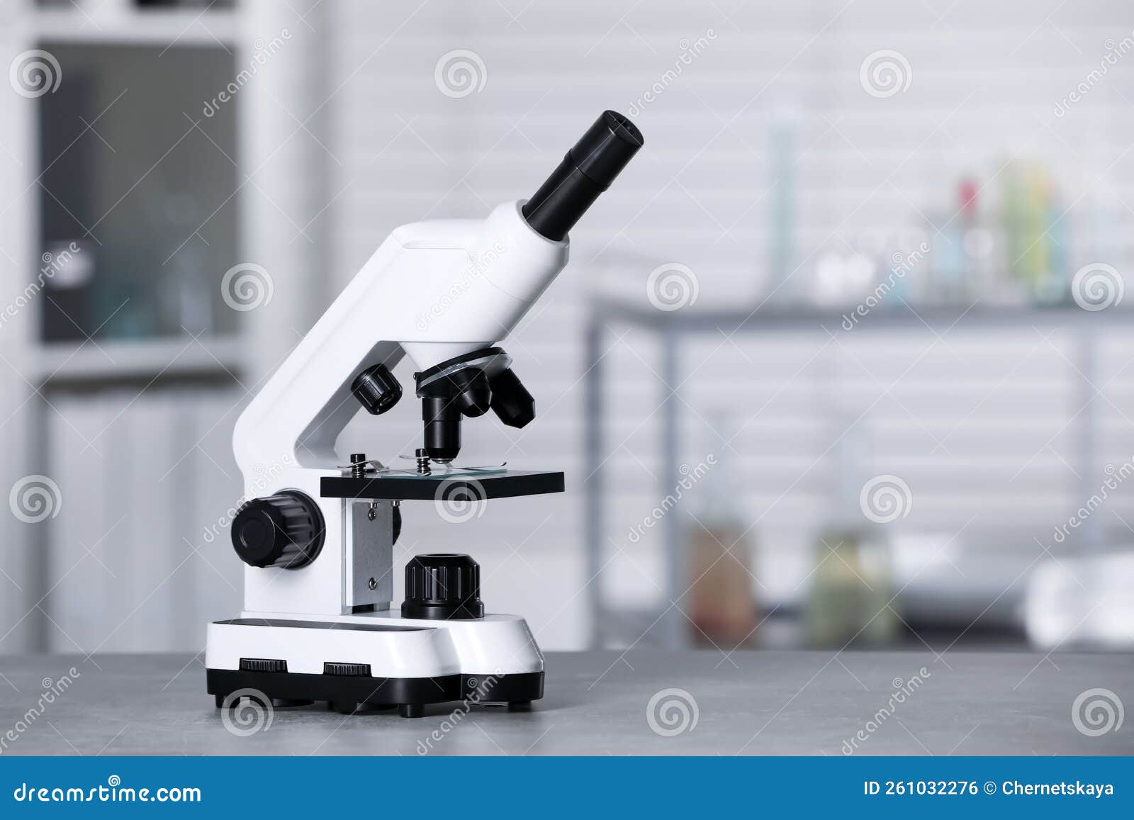 Modern Medical Microscope on Grey Table in Laboratory, Space for Text ...