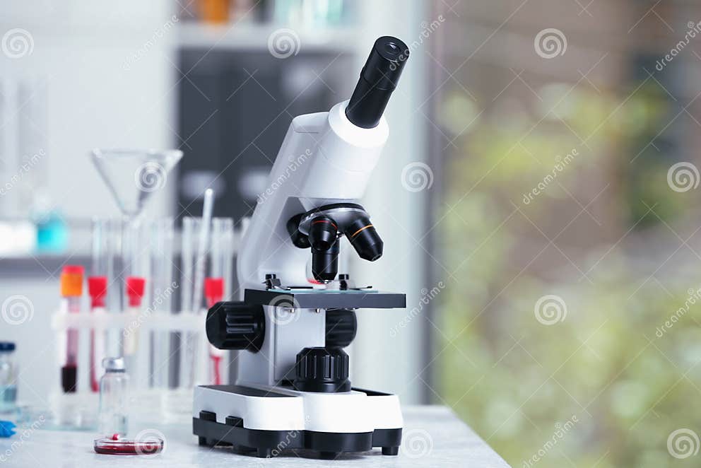 Modern Medical Microscope on Light Gray Table in Laboratory. Space for ...