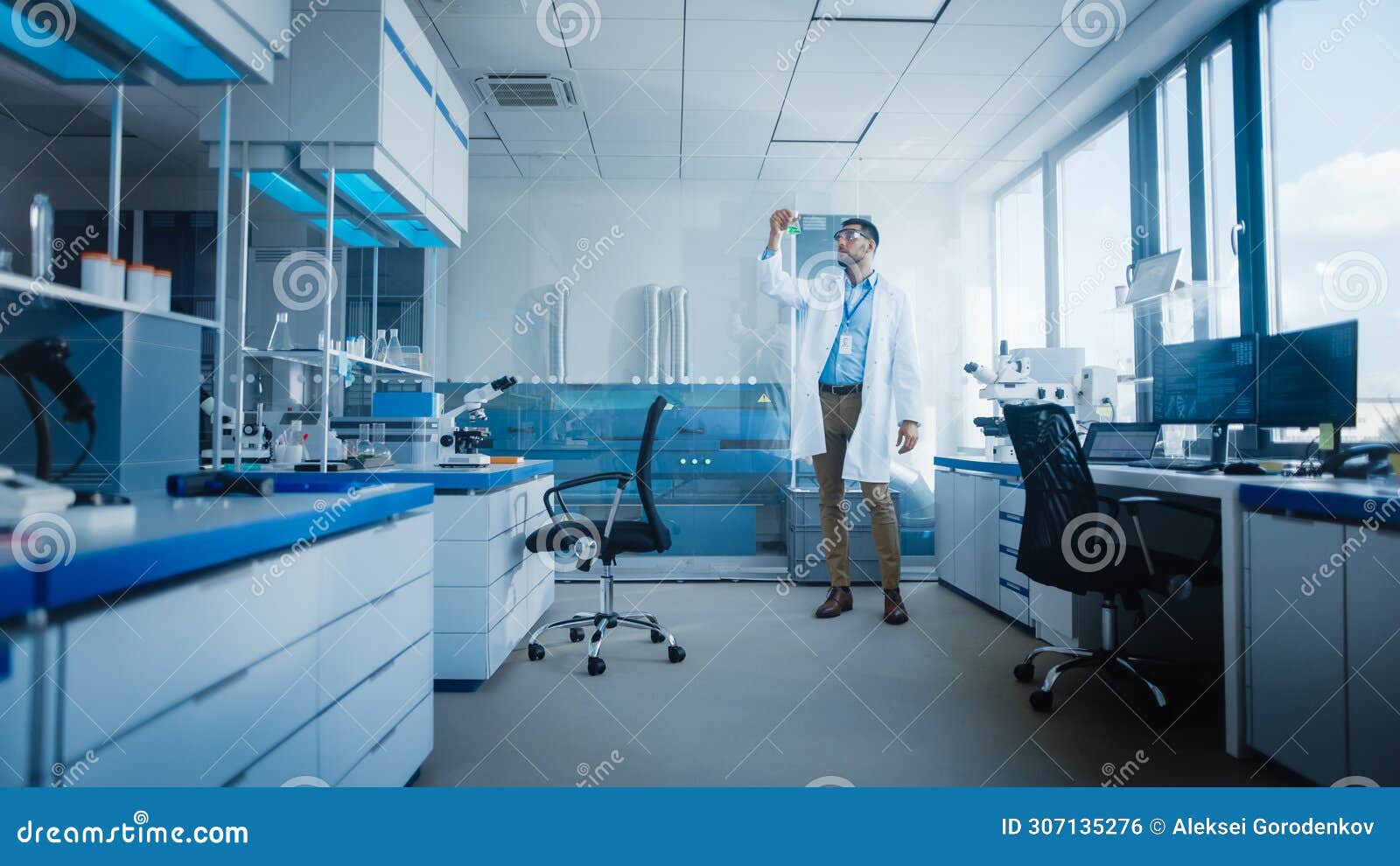 Modern Medical Research Laboratory with Male Scientist Analysing ...