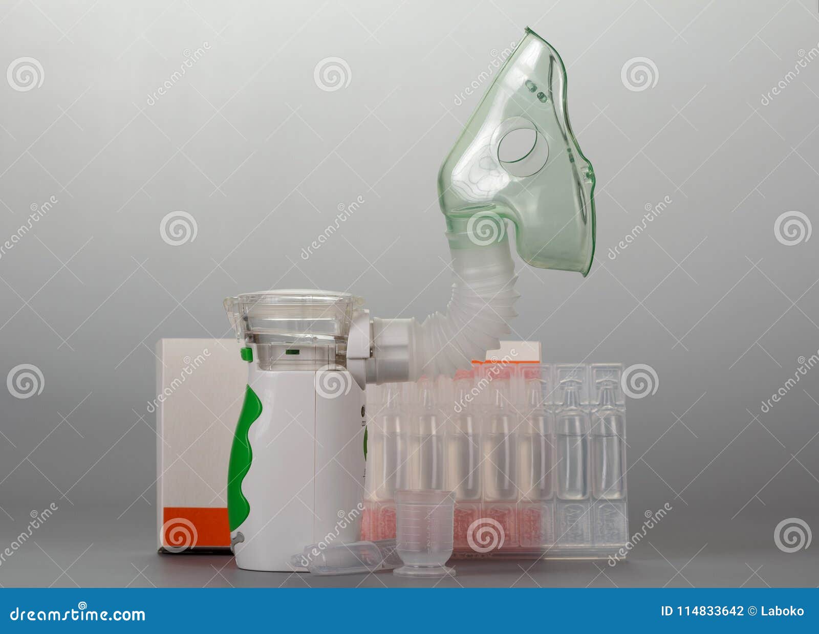 Modern Mesh-nebulizer, Box of Vials and Beaker on Gray Stock Photo ...