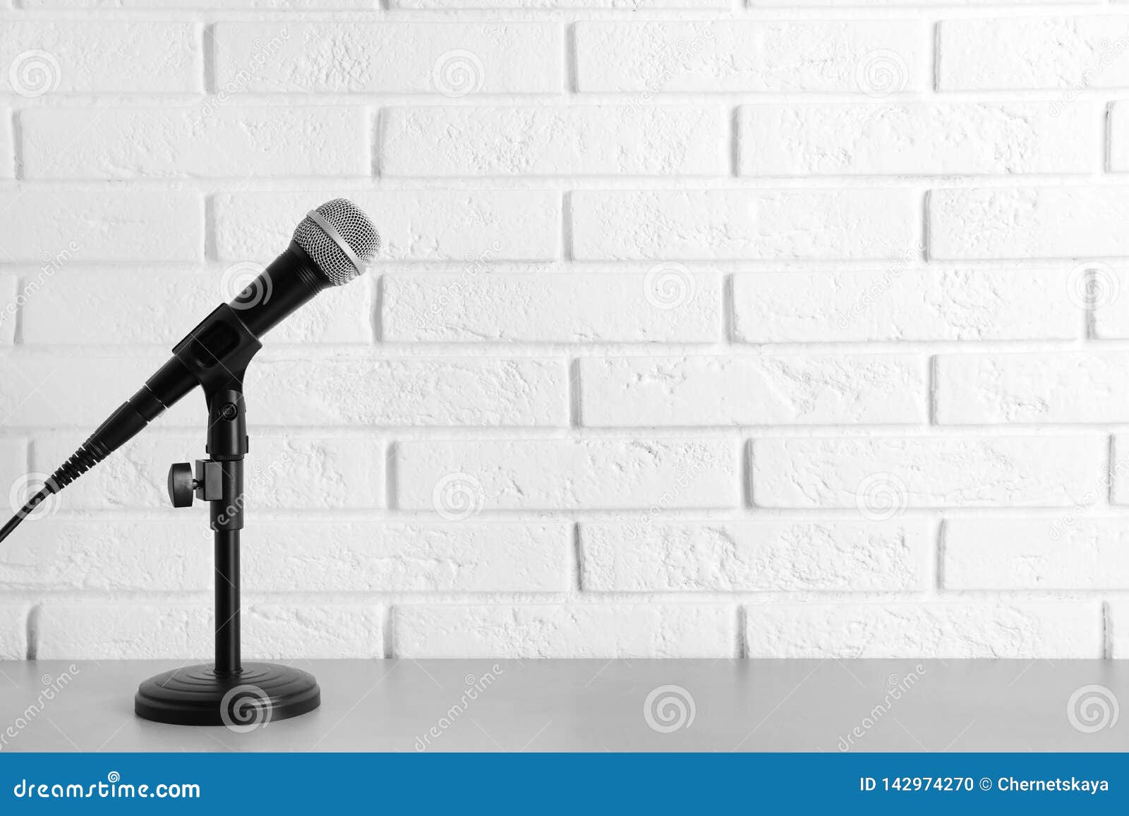 Modern Microphone on Table Near Wall. Space for Text Stock Photo ...