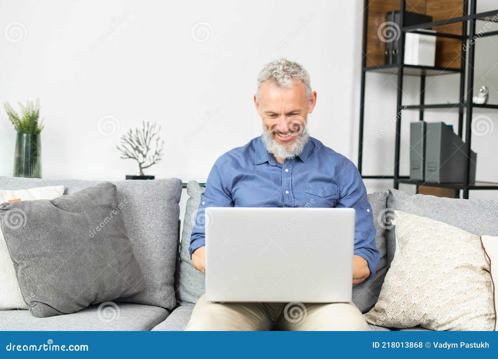 Modern Middle-aged Bearded Man Using Laptop Computer Sitting on the ...