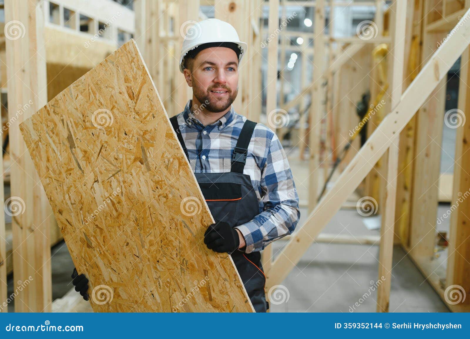 Modern Modular House. a Worker Works on the Construction of a Wooden ...