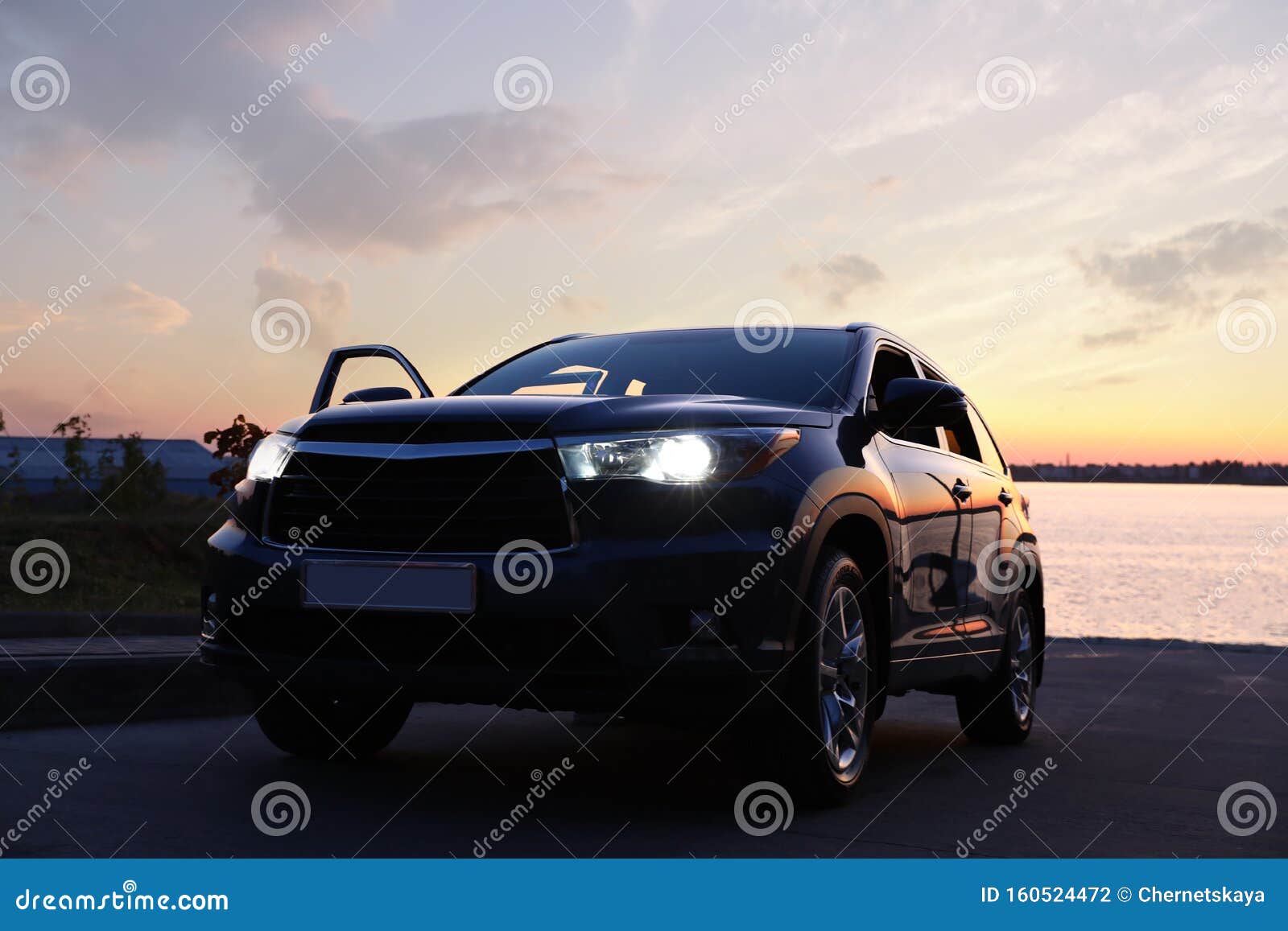 Modern new car on road stock photo. Image of sunset - 160524472