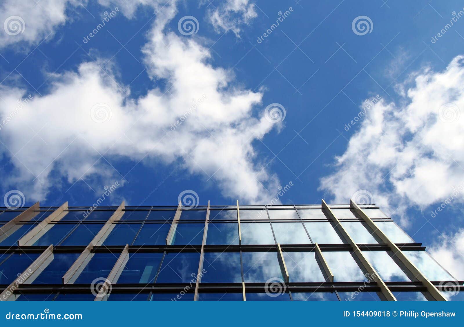 Modern Office Building with Mirrored Glass Windows Reflecting a Bright ...
